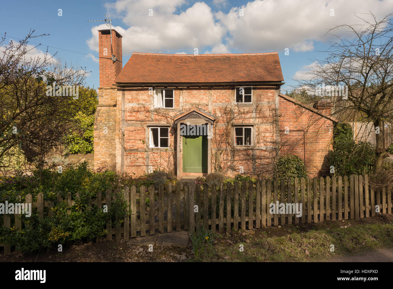 Brick house picket fence hi-res stock photography and images - Alamy