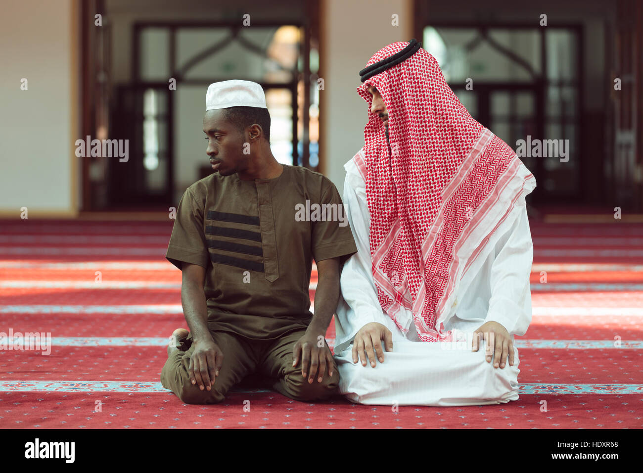 Two religious muslim man praying together inside the mosque Stock Photo ...