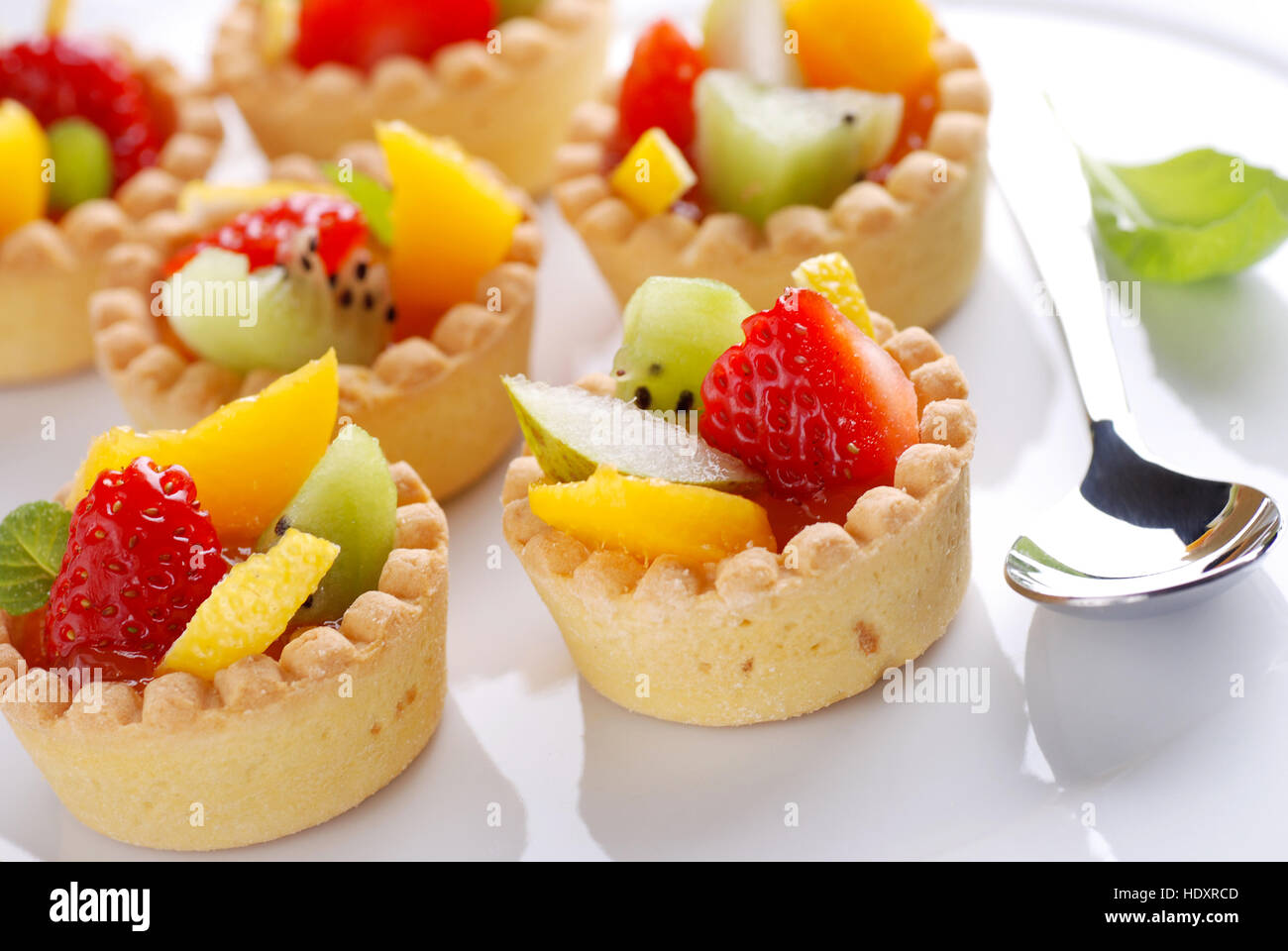 pastry tartlets with fruit inside the white tray Stock Photo - Alamy
