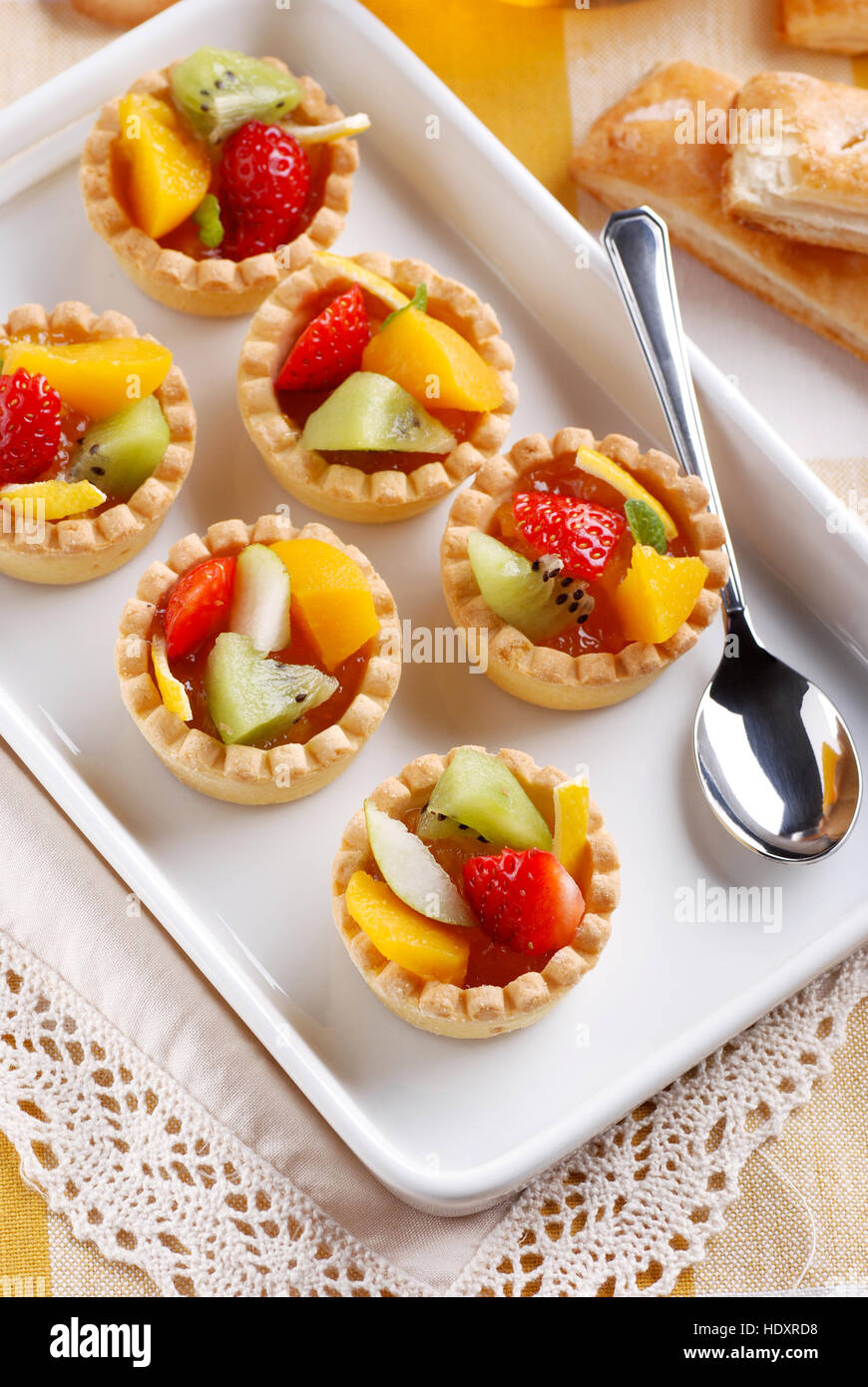 pastry tartlets with fruit inside the white tray Stock Photo - Alamy
