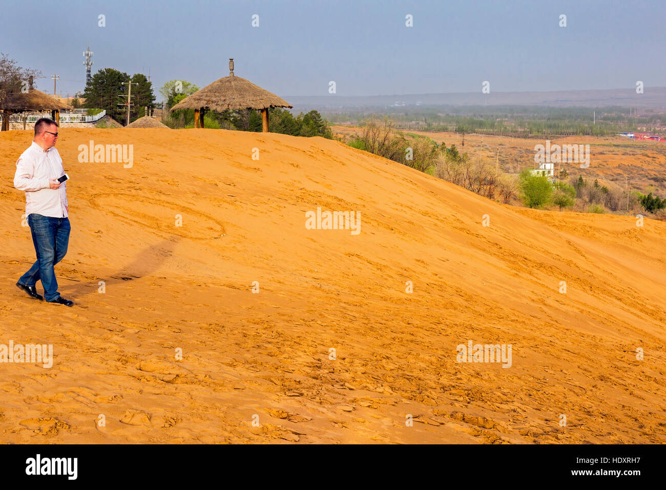 Lone tourist in the desert at esert at Shapotou Scenic Area, Zhongwei ...