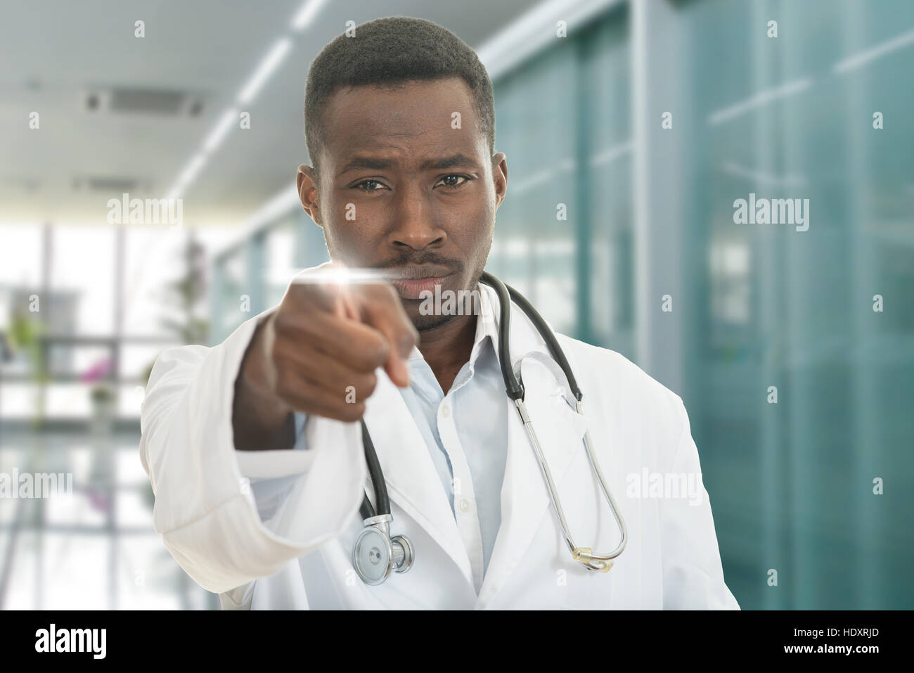 Angry african black male doctor pointing finger at you with stethoscope ...
