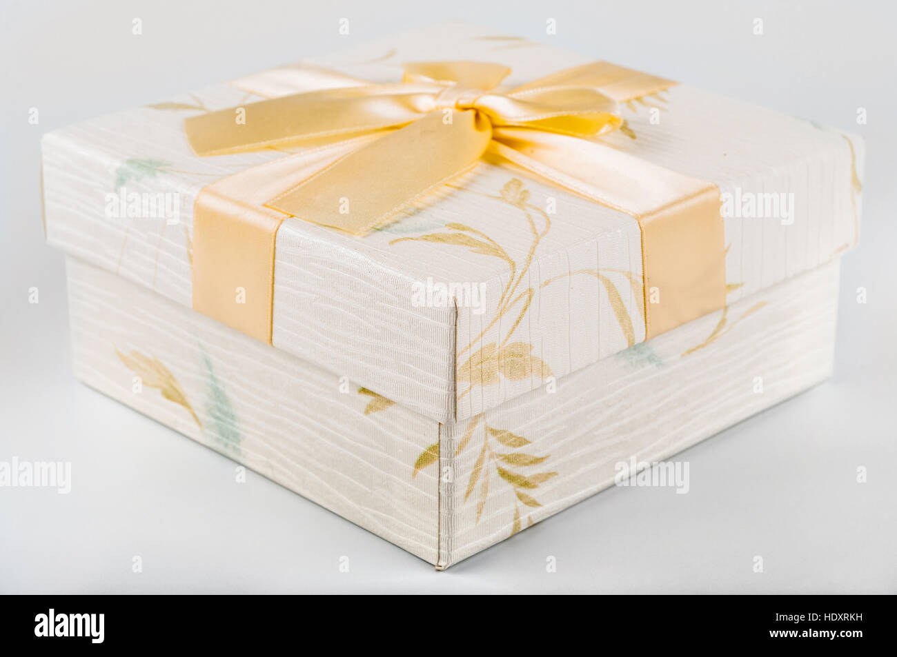 Beutiful gift box with flowers and golden ribbon Stock Photo - Alamy