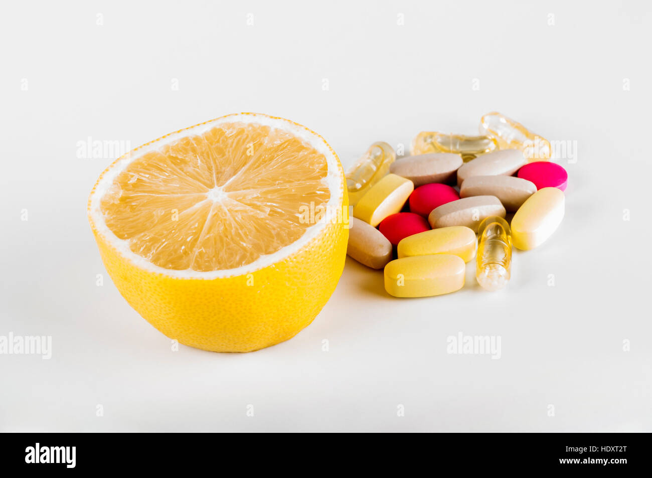 Fruits vs synthetic vitamins on white background Stock Photo - Alamy