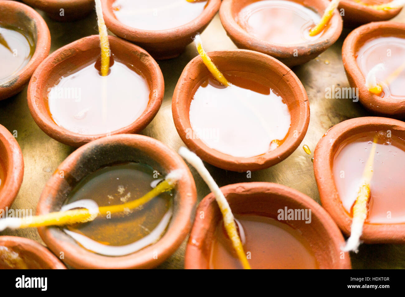 Indian earthenware lamps filled with oil and a cotton wick. These diyas ...