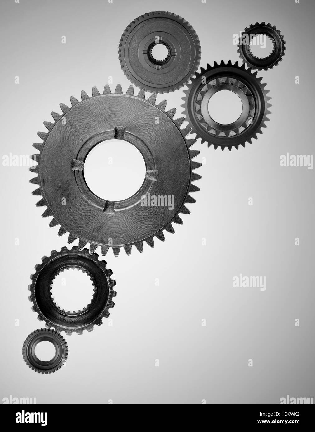Metal cog wheels bonding together Stock Photo - Alamy