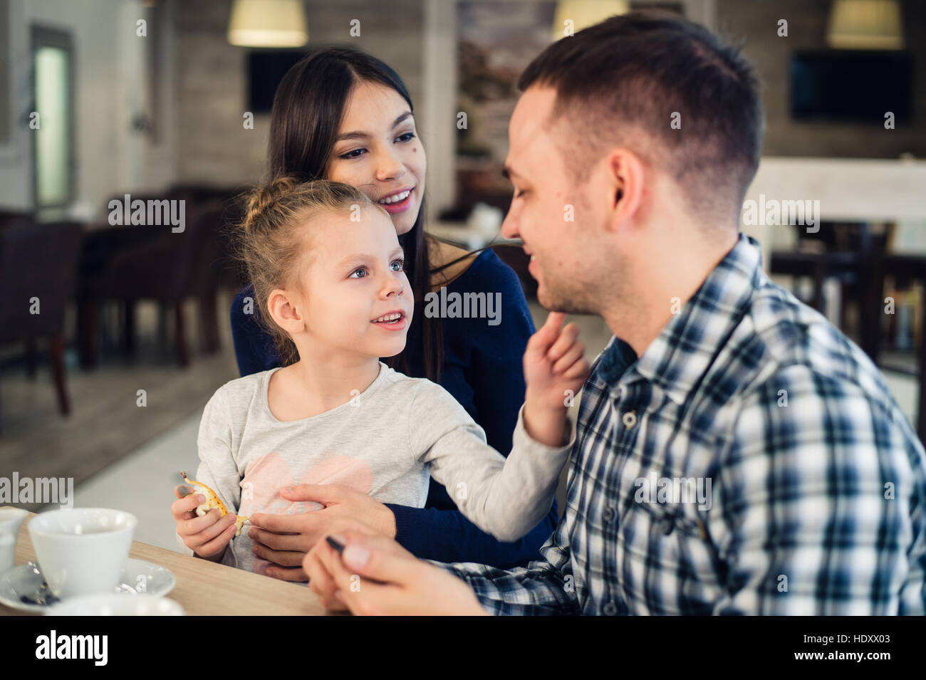Family Enjoying tea In Cafe Together Stock Photo - Alamy