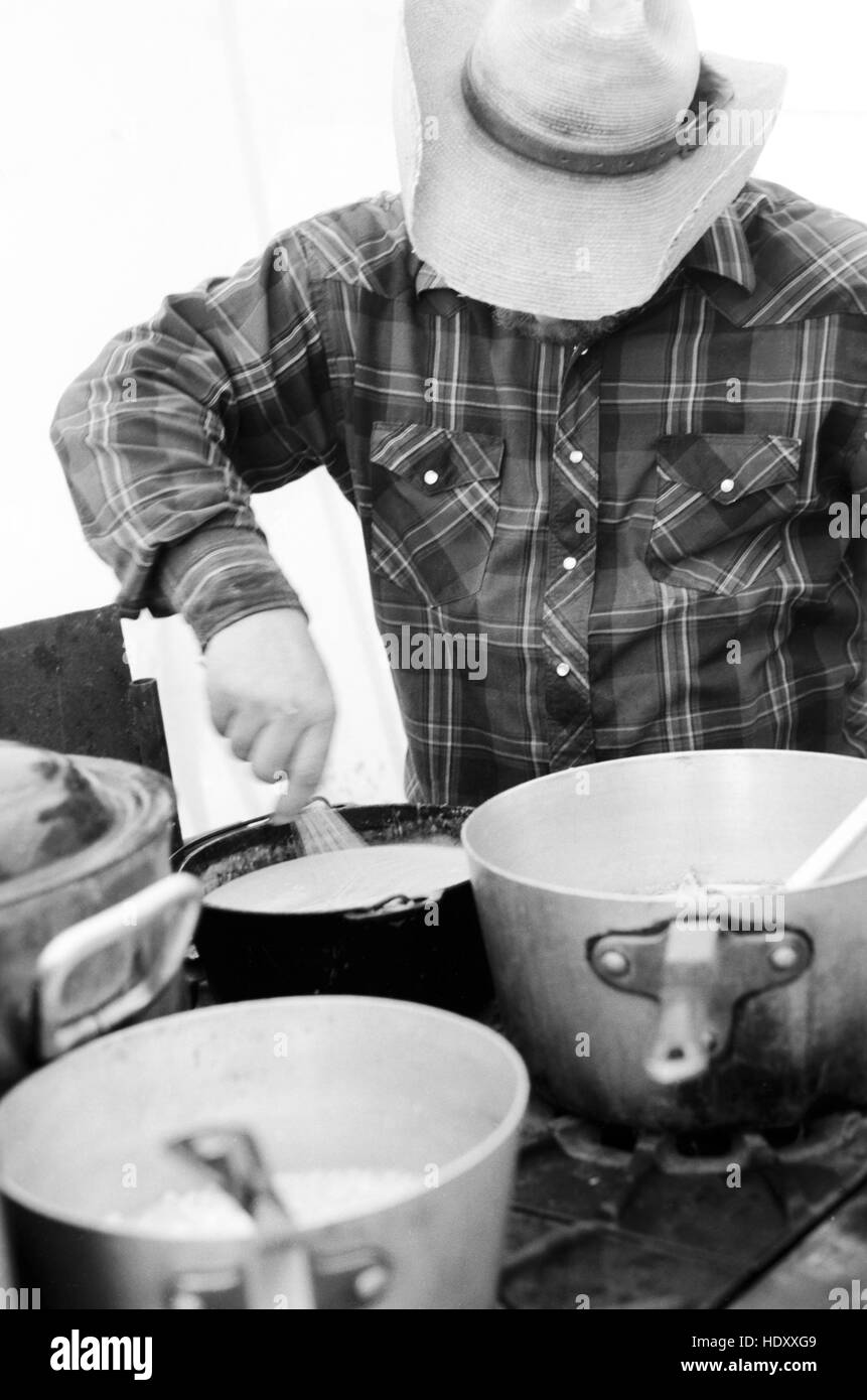 Chuckwagon cook keeping busy in the morning on the Triangle Ranch near ...