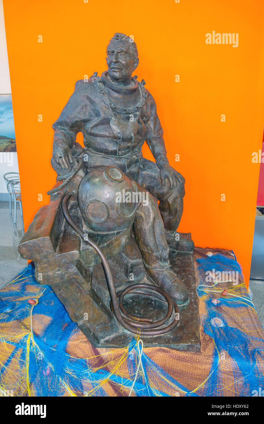 Bronze statue of sponge diver in diving suite with nets at Kalymnos ...