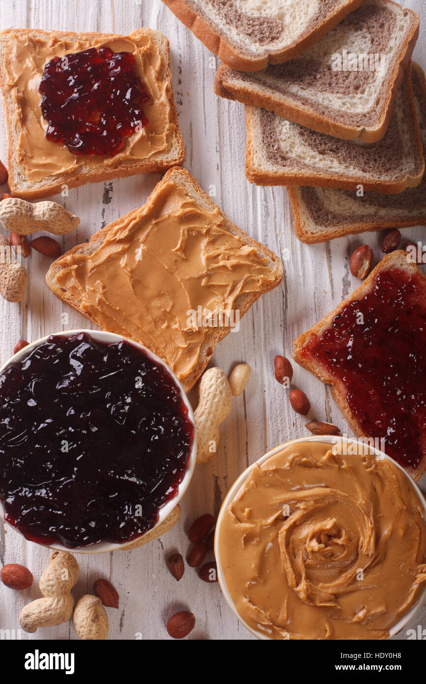 Toast with peanut butter and jam closeup on the table. vertical top ...
