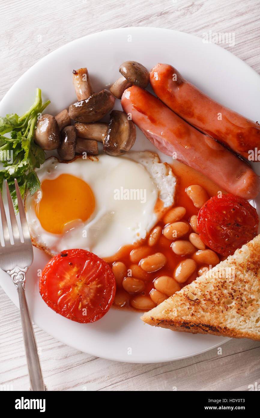 English breakfast: eggs, sausage, tomato, beans and mushrooms close-up ...