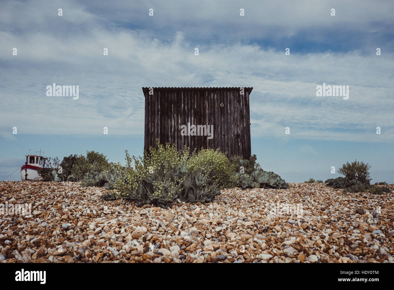 Old metal hut on a pebbly beach Stock Photo - Alamy