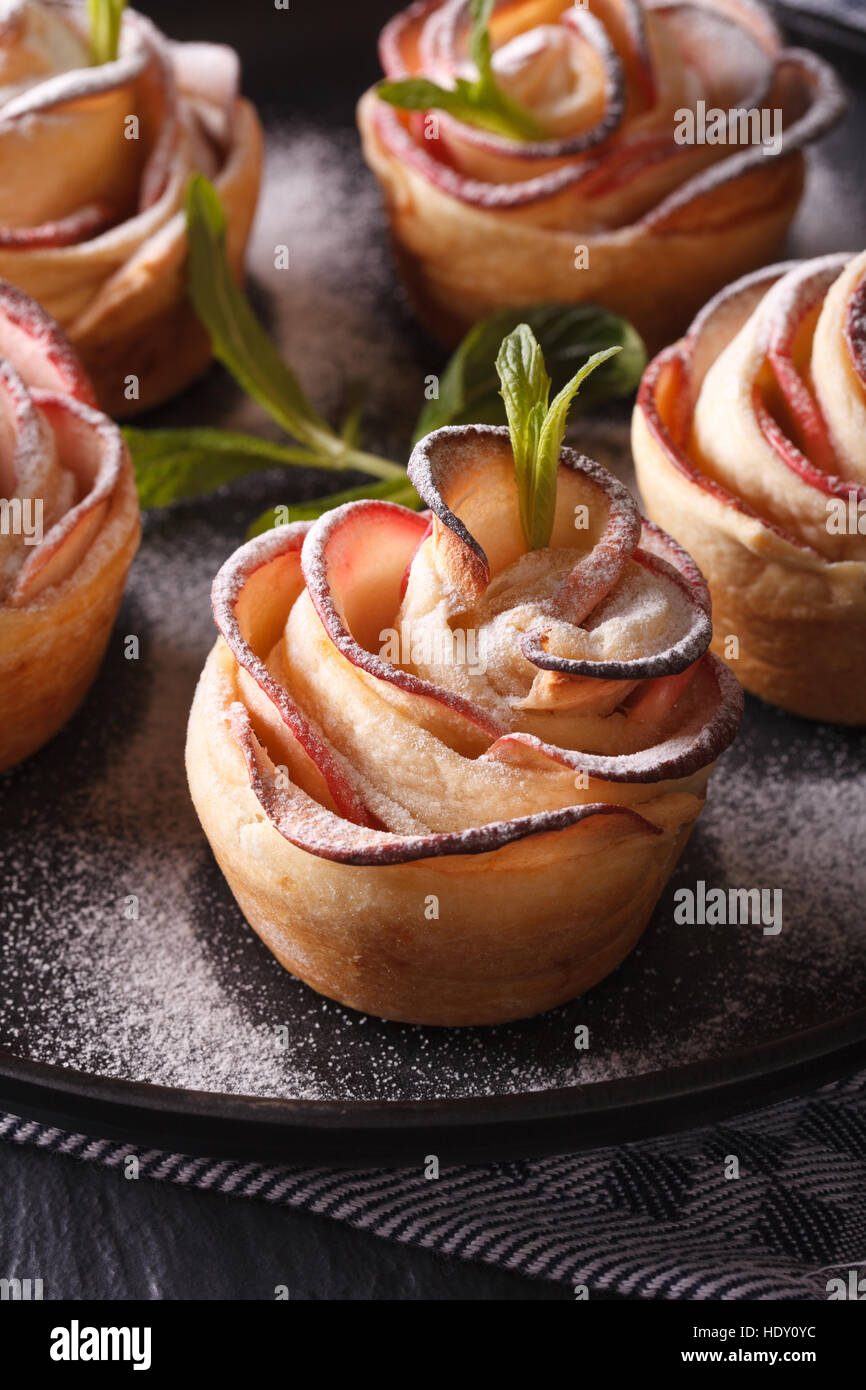 healthy food: apple pie in the form of roses on a black plate macro ...