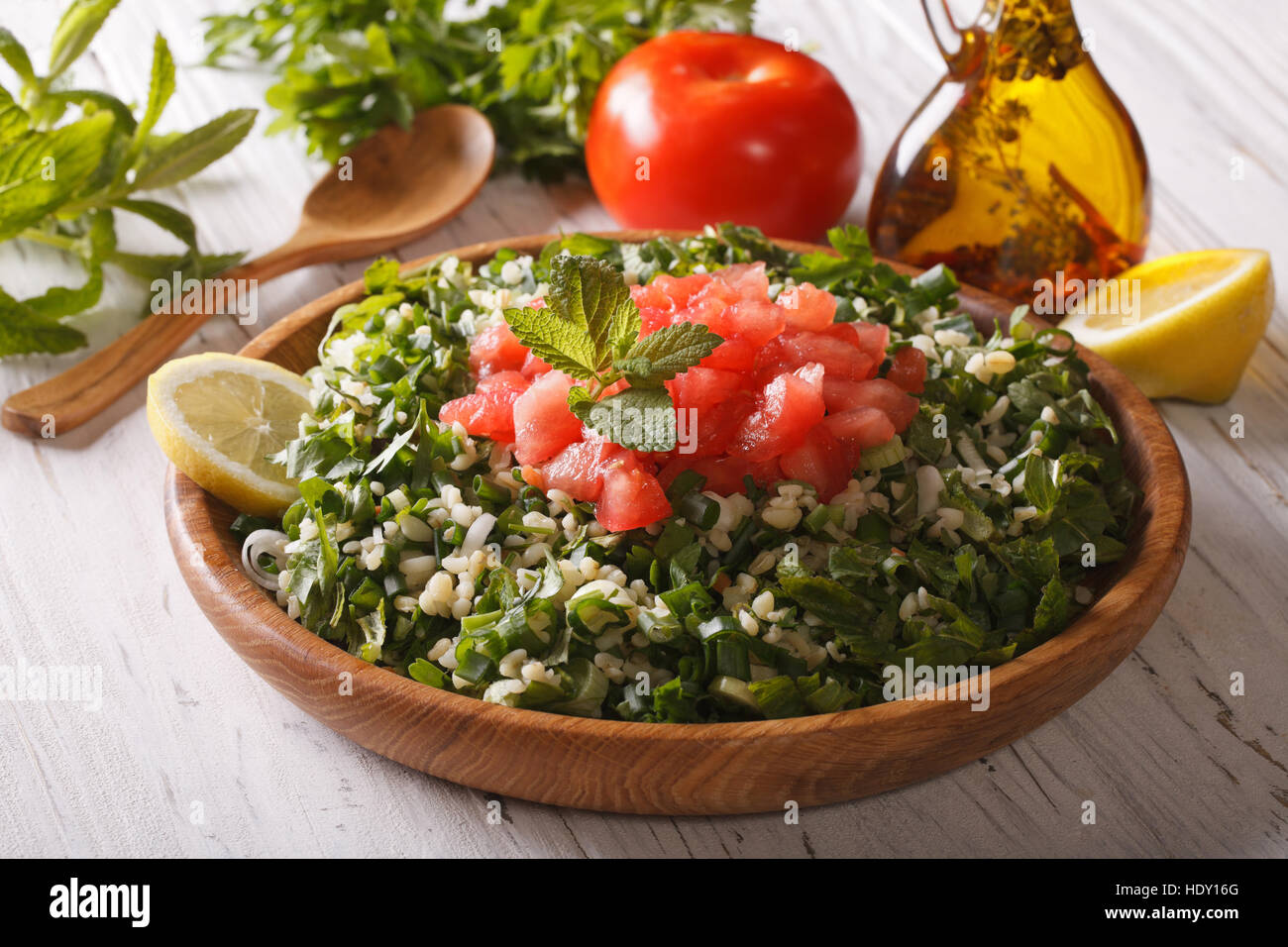 Arabic Salad Tabbouleh close up in a wooden bowl and ingredients ...