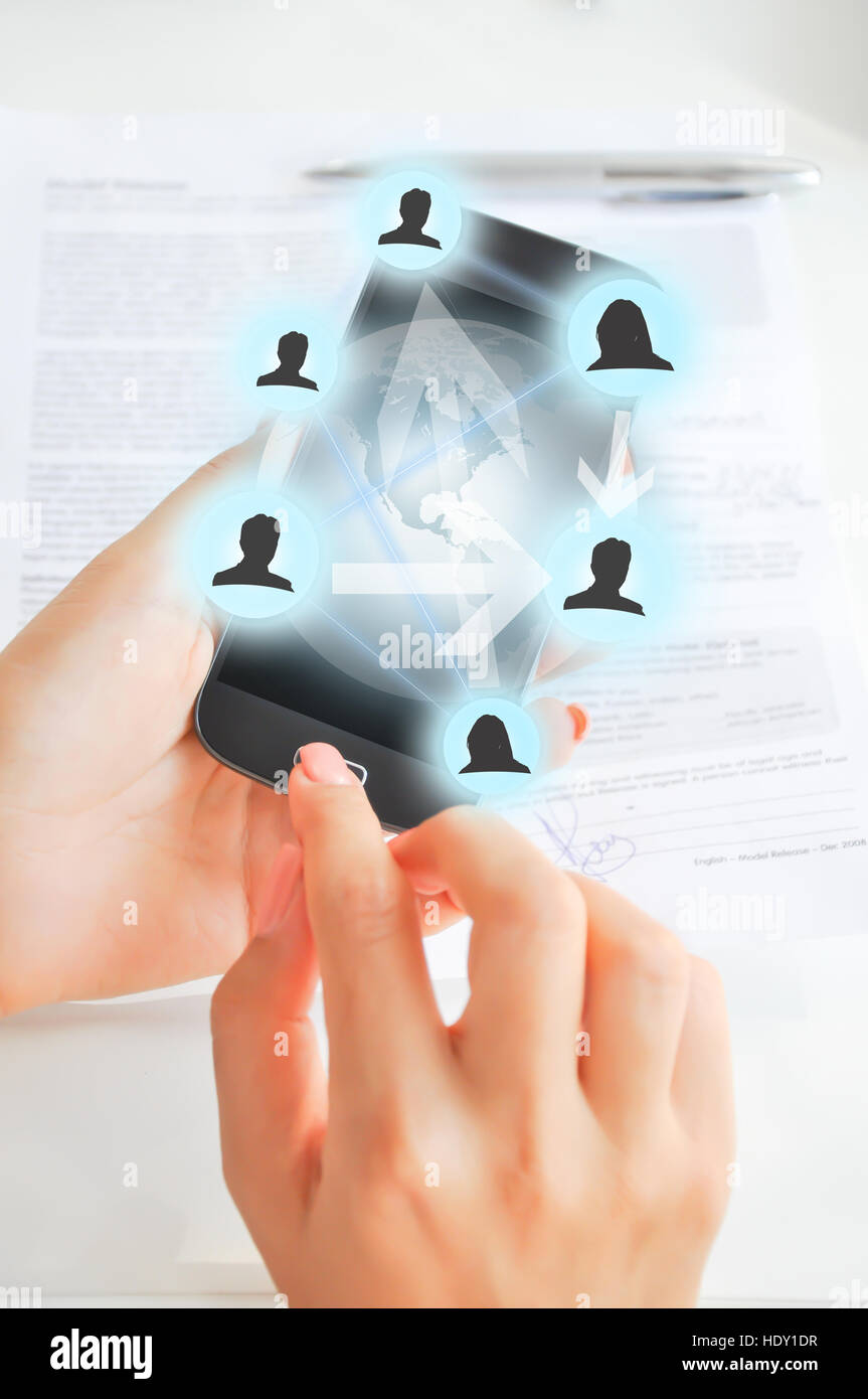 Modern communication technology with human finger touching a smartphone ...