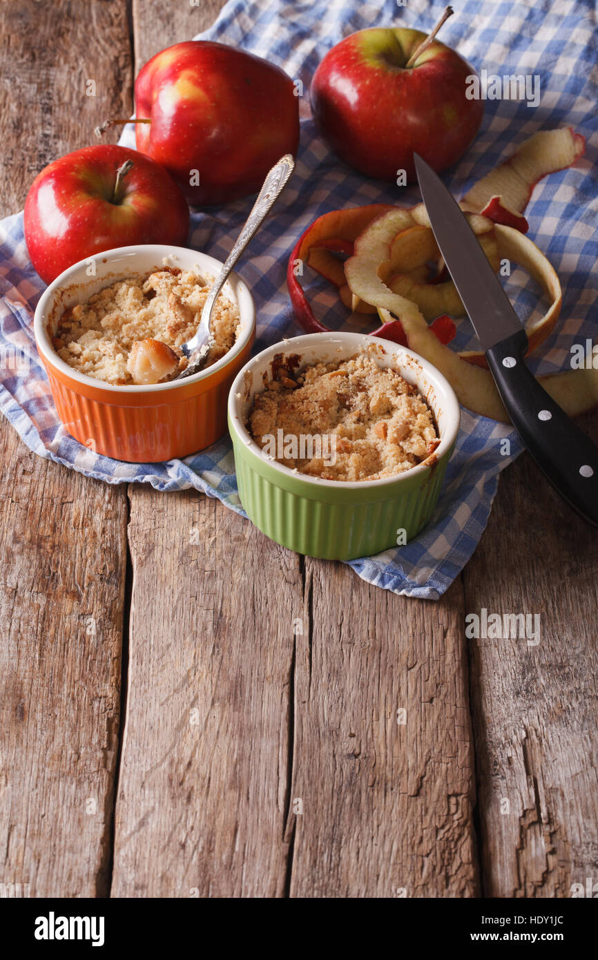 apple crumble in pots for baking on the table. Vertical rustic style ...