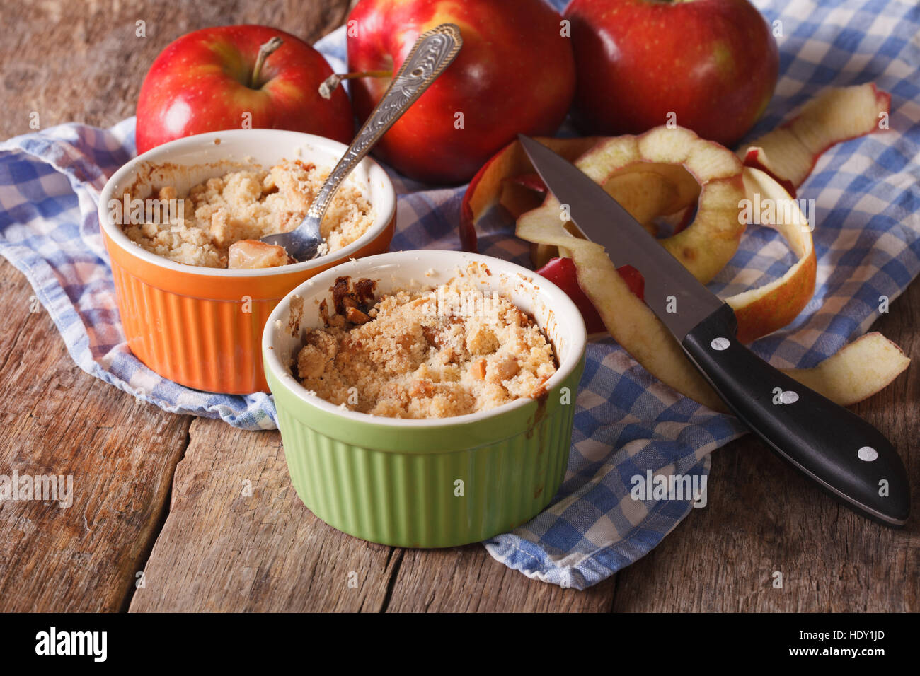 crumble with apples close-up in the pot on the table. Horizontal rustic ...