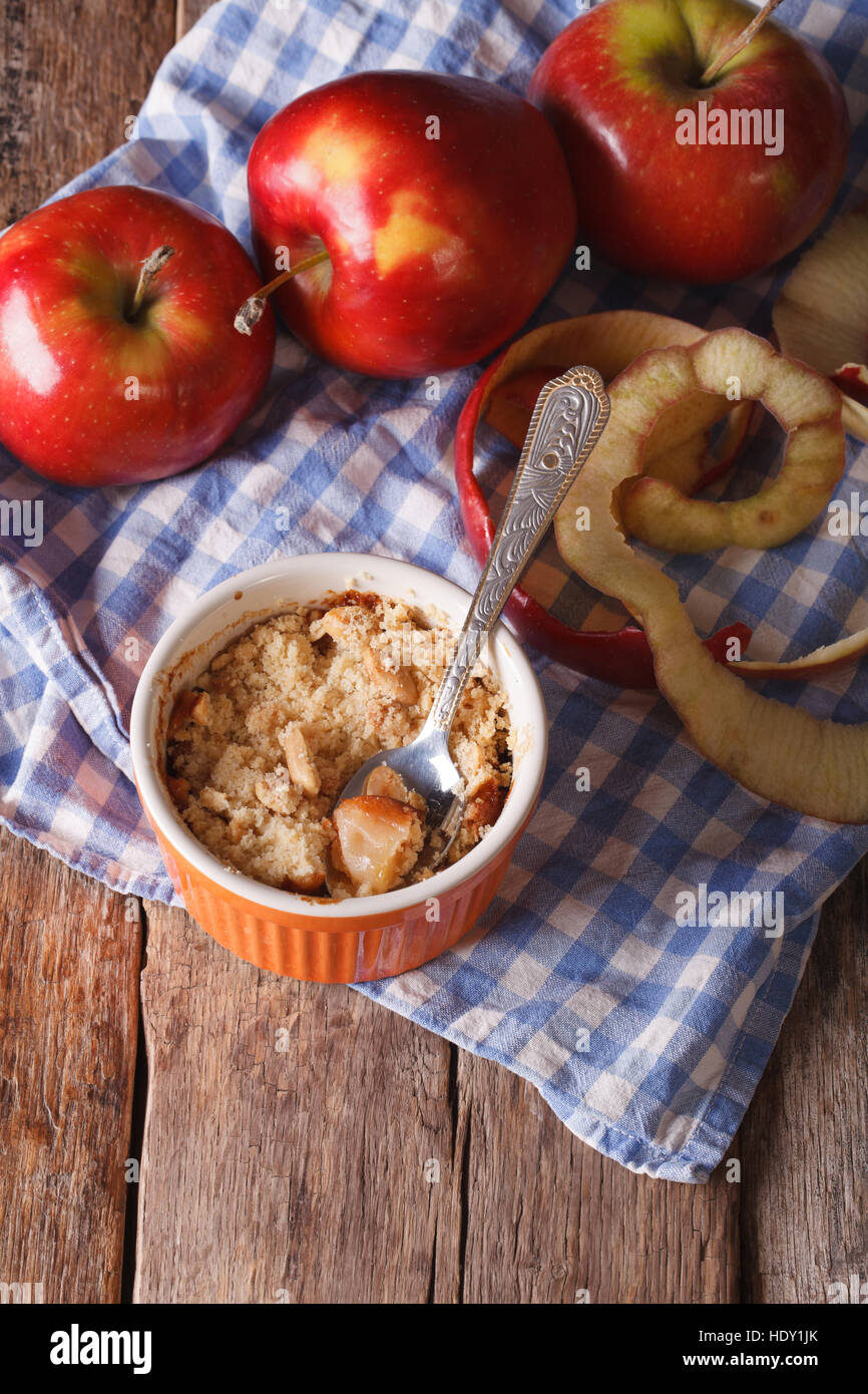 Traditional apple crumble close-up in a pot. view from above vertical ...