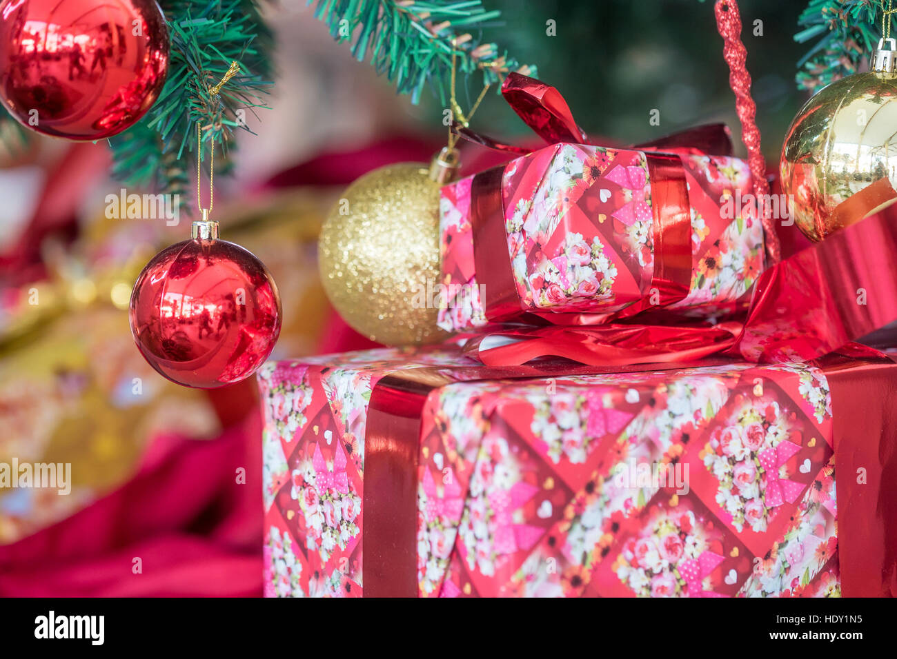 Christmas gift boxes under fir-tree with decorations Stock Photo - Alamy