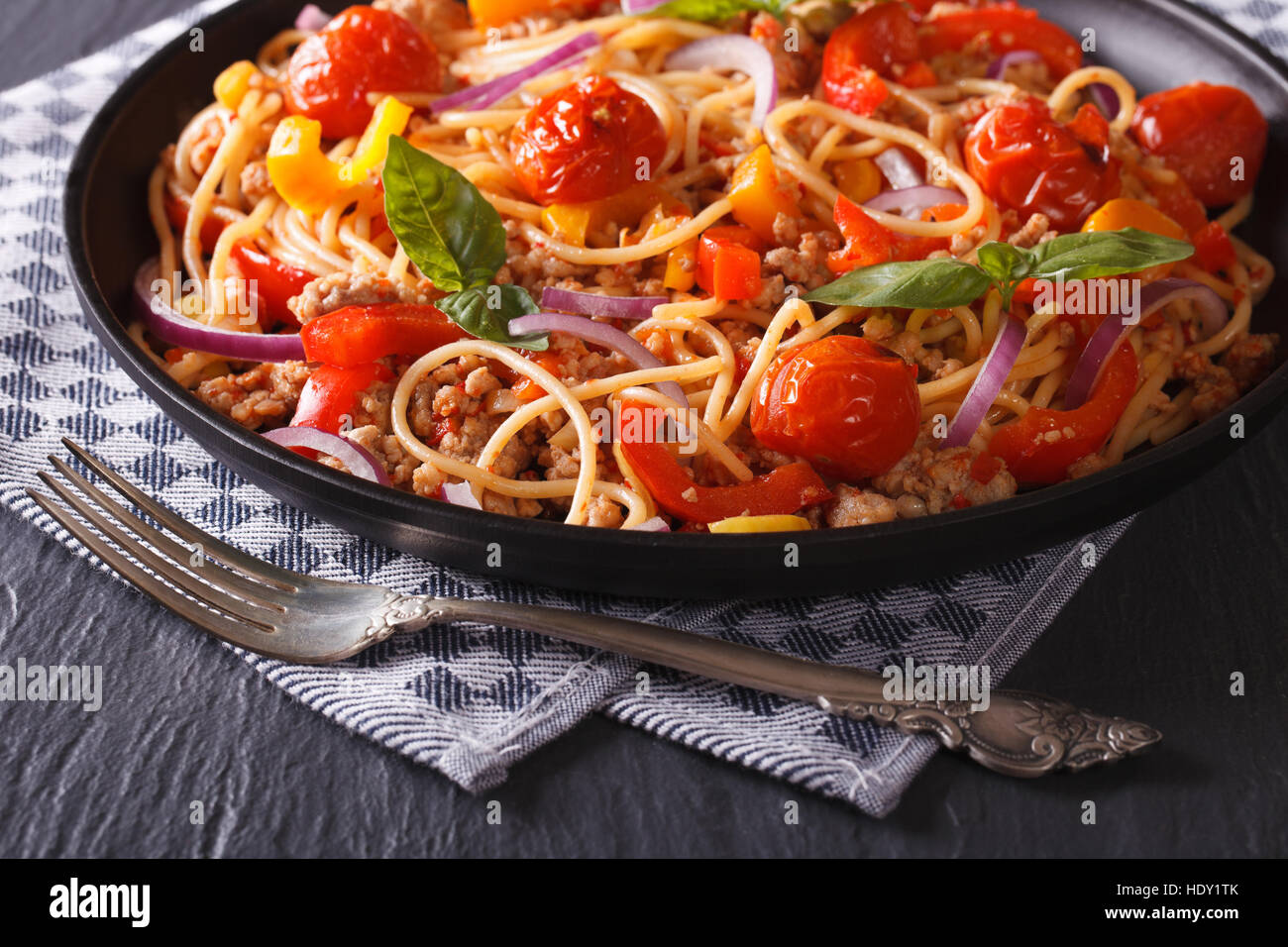 Delicious spaghetti with minced meat and vegetables close-up ...
