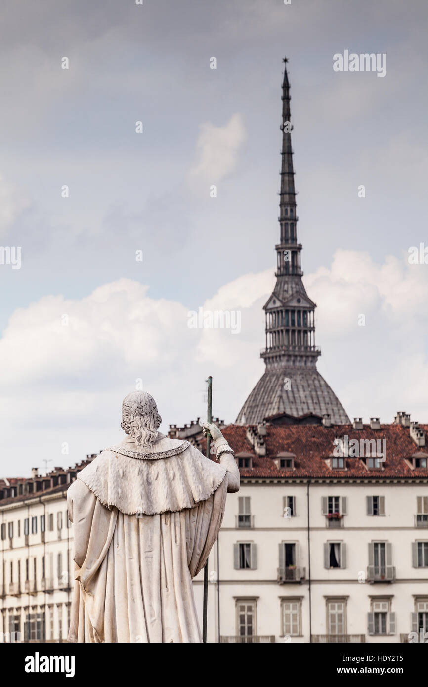 A statue in front of Gran Madre di Dio looks over to Mole Antonelliana ...