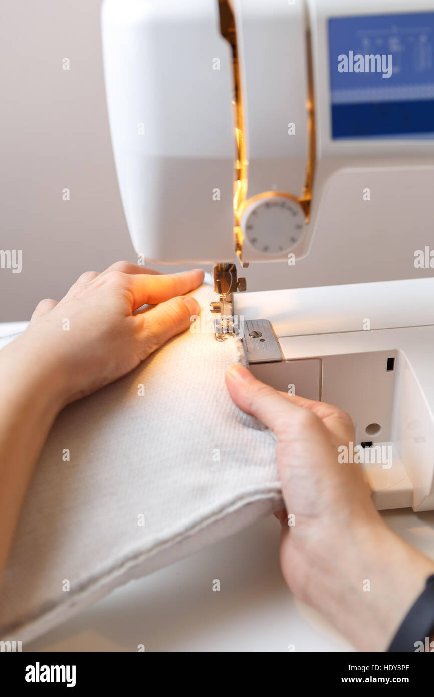 Photos of seamstress working at sewing machine at home Stock Photo - Alamy