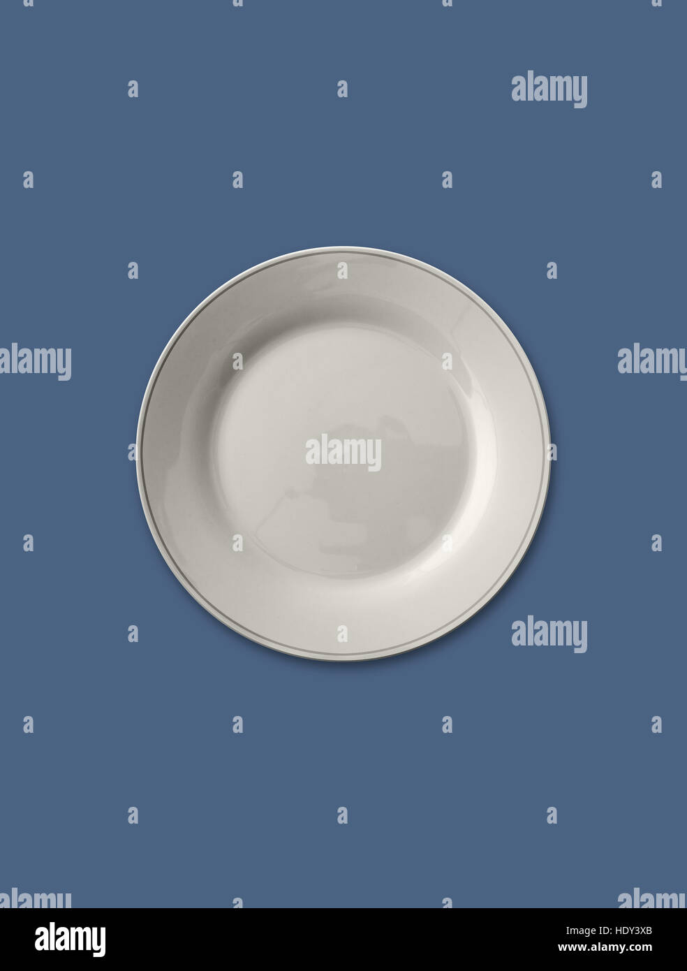 Isolated empty plate on solid gray blue color background Stock Photo ...