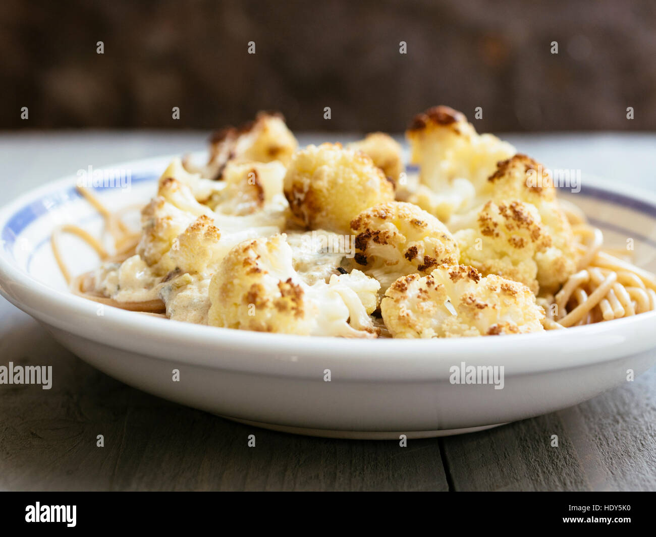 Roasted cauliflower over whole grain spaghetti Stock Photo - Alamy