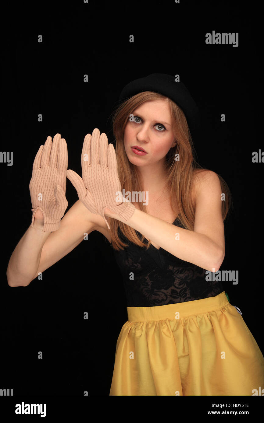 portrait of a pretty young girl making expression on black background ...