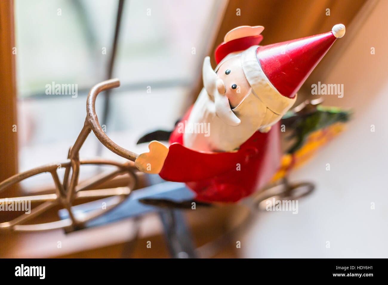 A tin metal father christmas decoration by a window in a home from ...