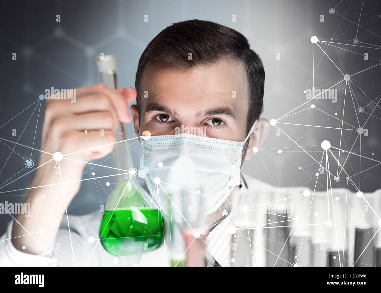 Portrait of concentrated male scientist working with reagents in ...