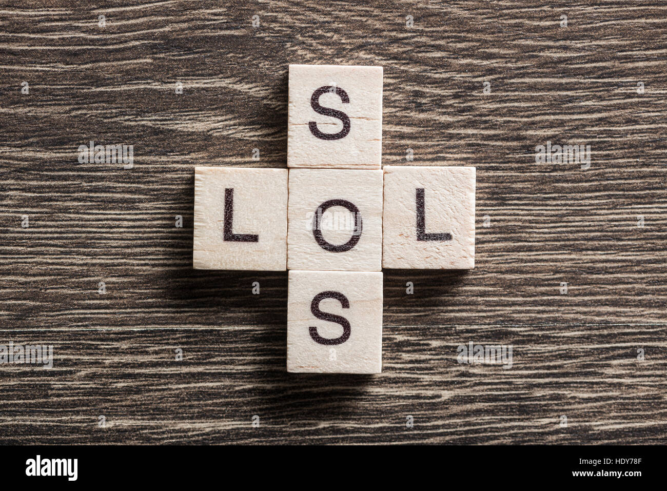 Words SOS and LOL on table made of wooden cubes elements Stock Photo ...