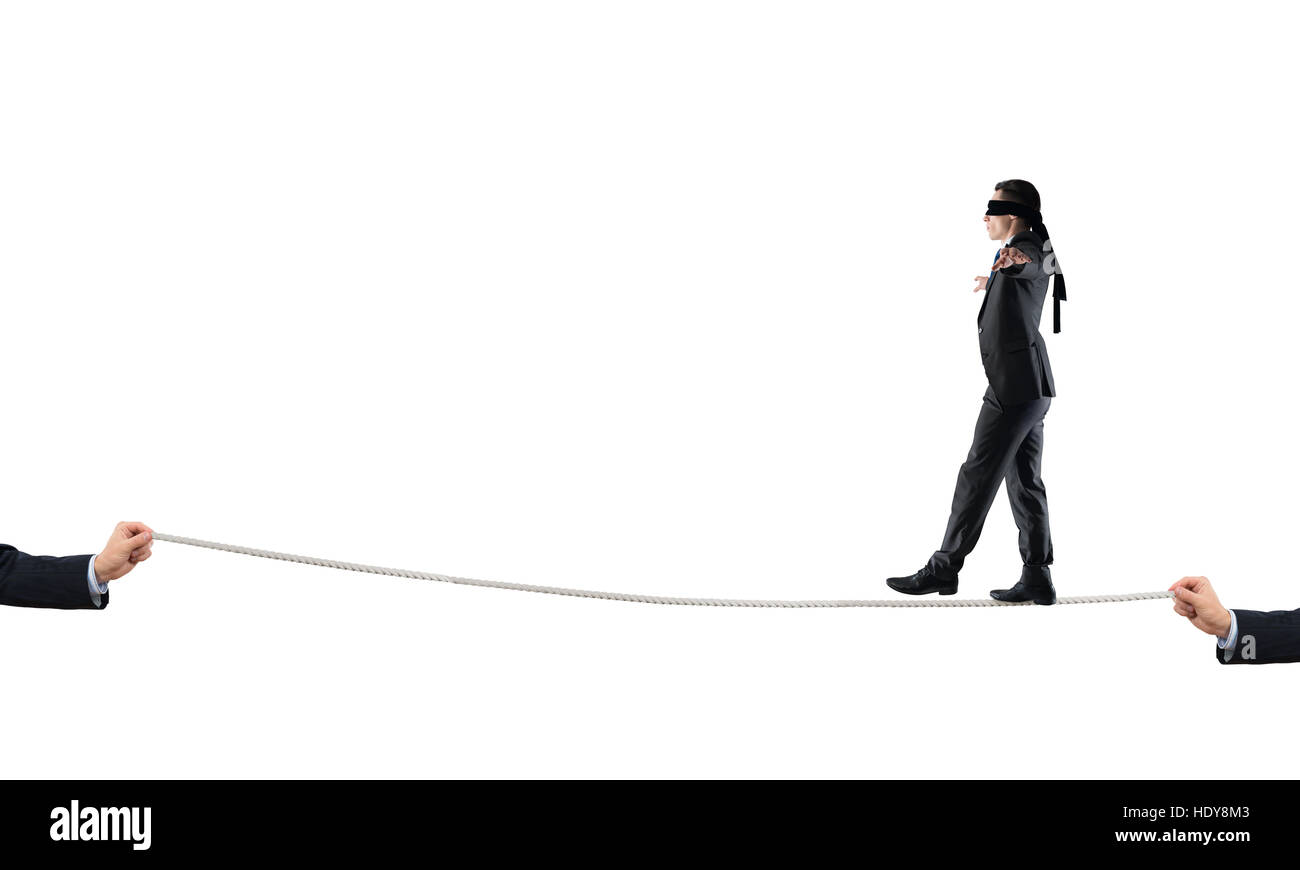 Young businessman in blindfold against white background walking on rope ...