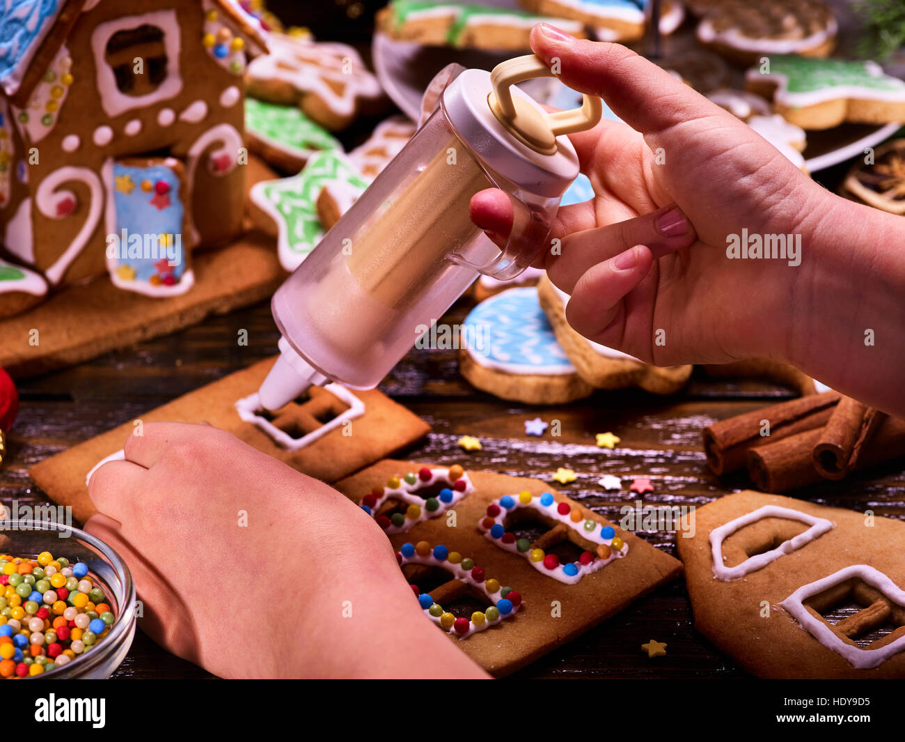 Gingerbread hause making by child hands Stock Photo - Alamy