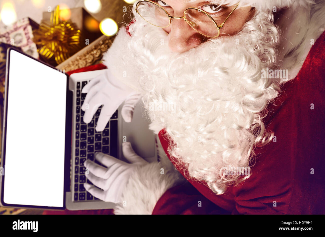Santa Claus working on modern laptop Stock Photo - Alamy