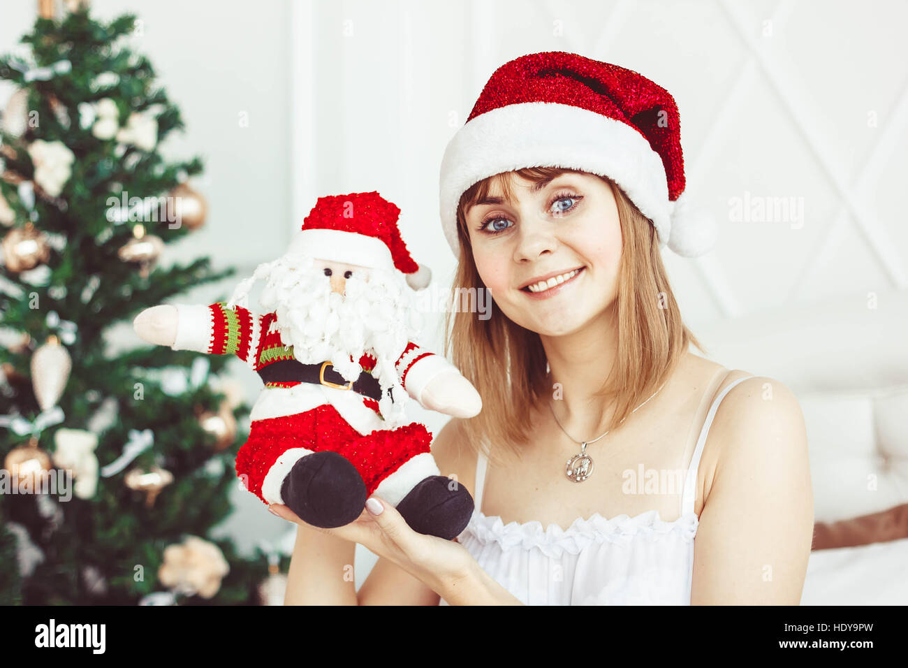 Santa girl with a toy Stock Photo - Alamy