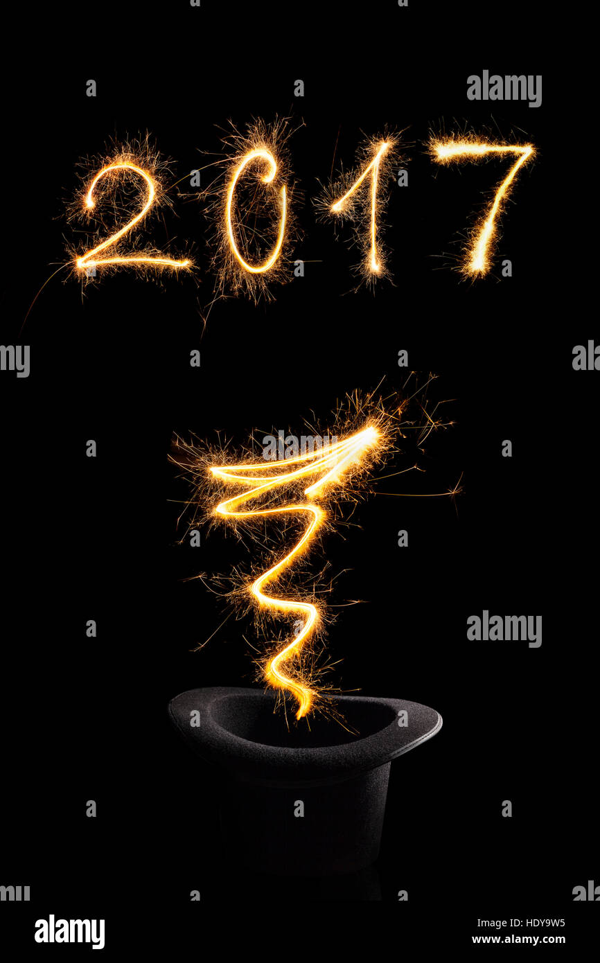 Magical new year. Magical fireworks from black top hat forming 2017 and ...