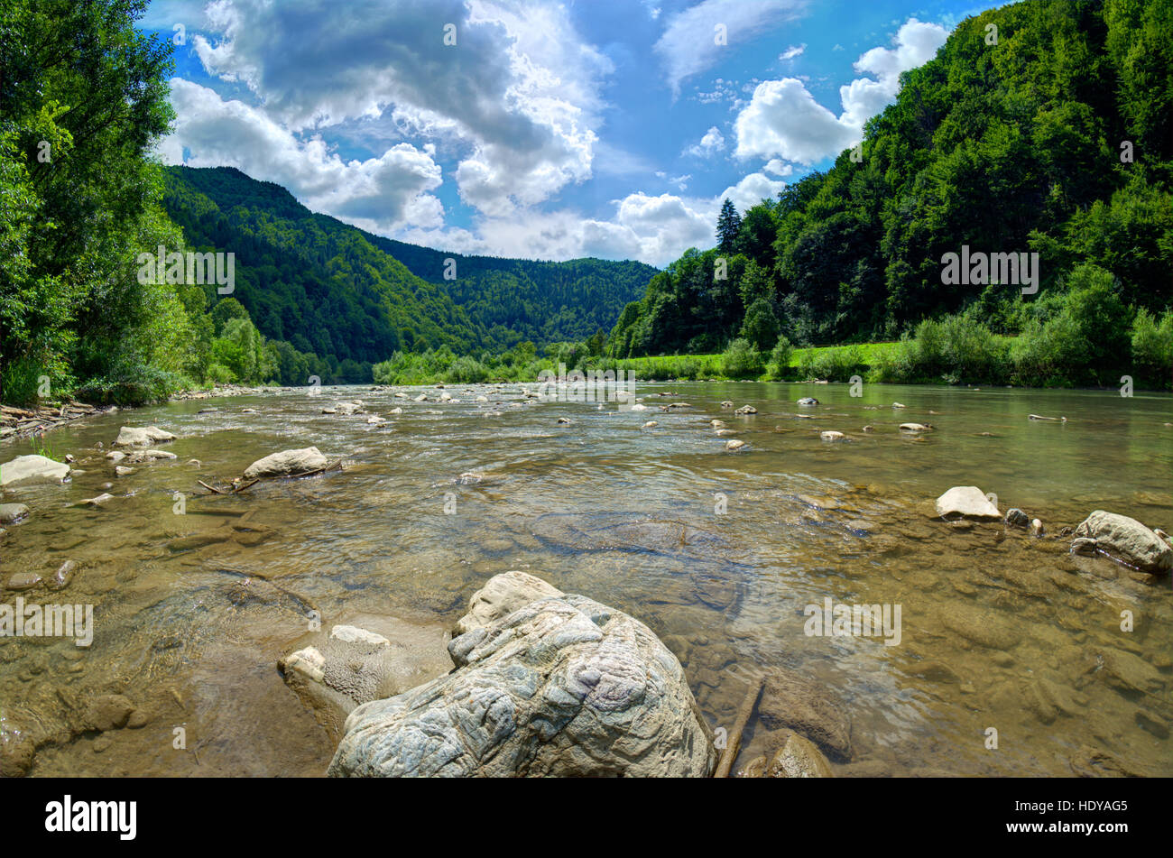 Natural rural landscape with mountains trees and a river in front ...