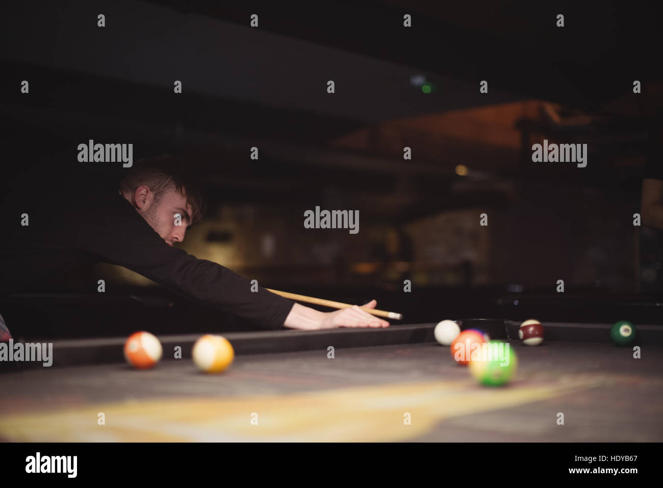 Young man playing pool playing pool in the billiards club Stock Photo ...