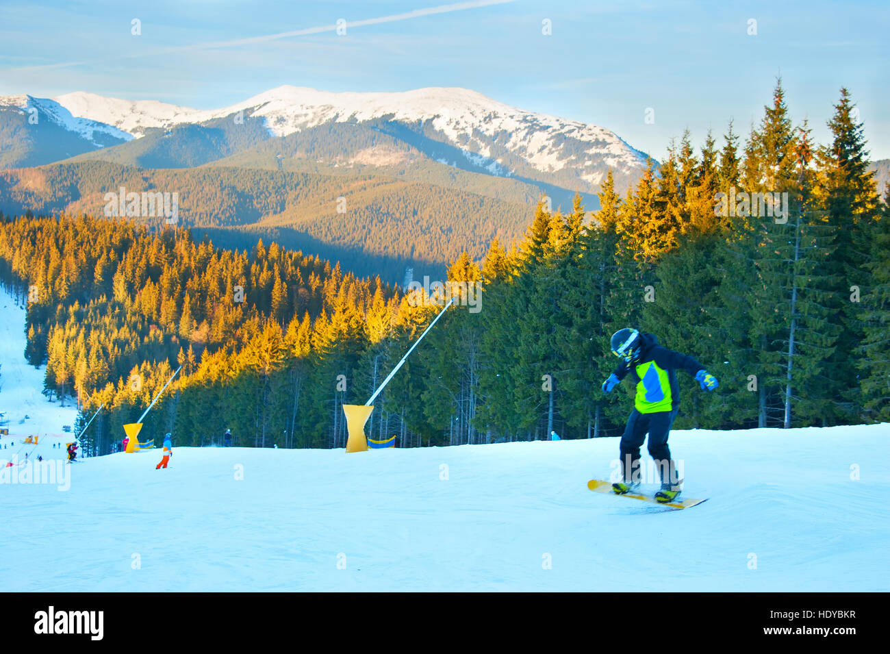 Snowboarder jumping on a mountains slope at sunset Stock Photo - Alamy