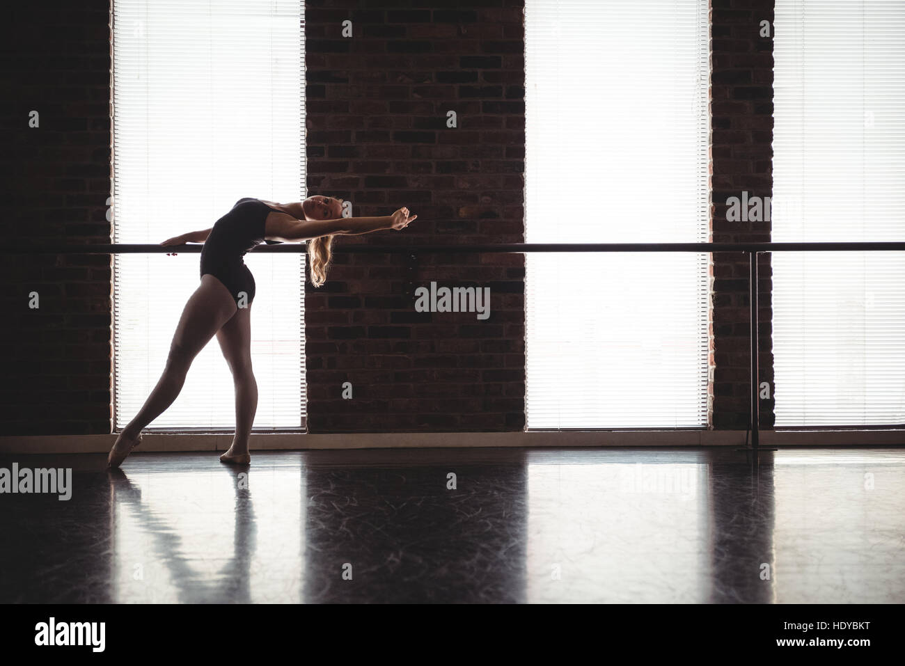 Ballerina practicing ballet dance at barre in the ballet studio Stock ...