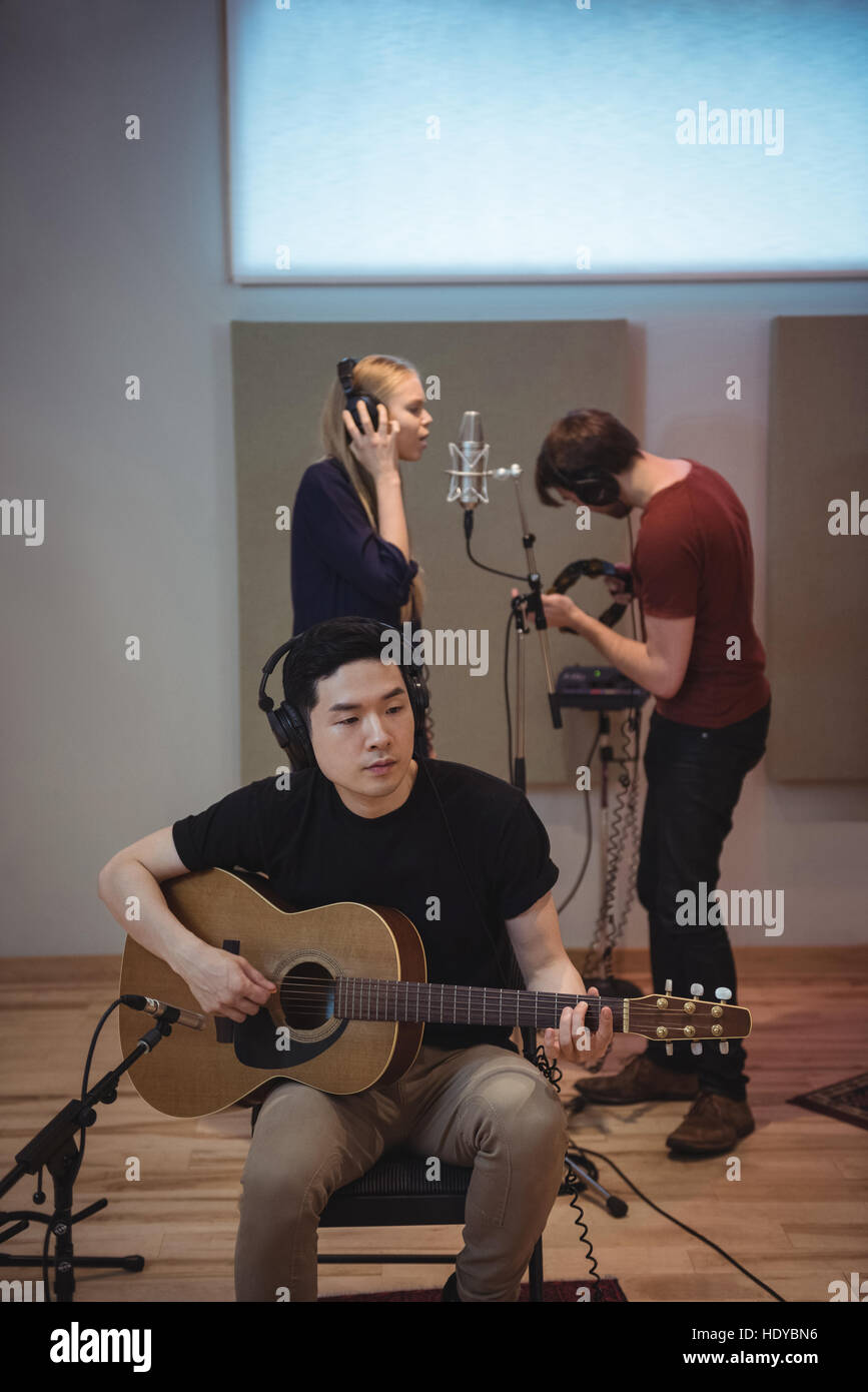 Music band performing in recording studio Stock Photo - Alamy