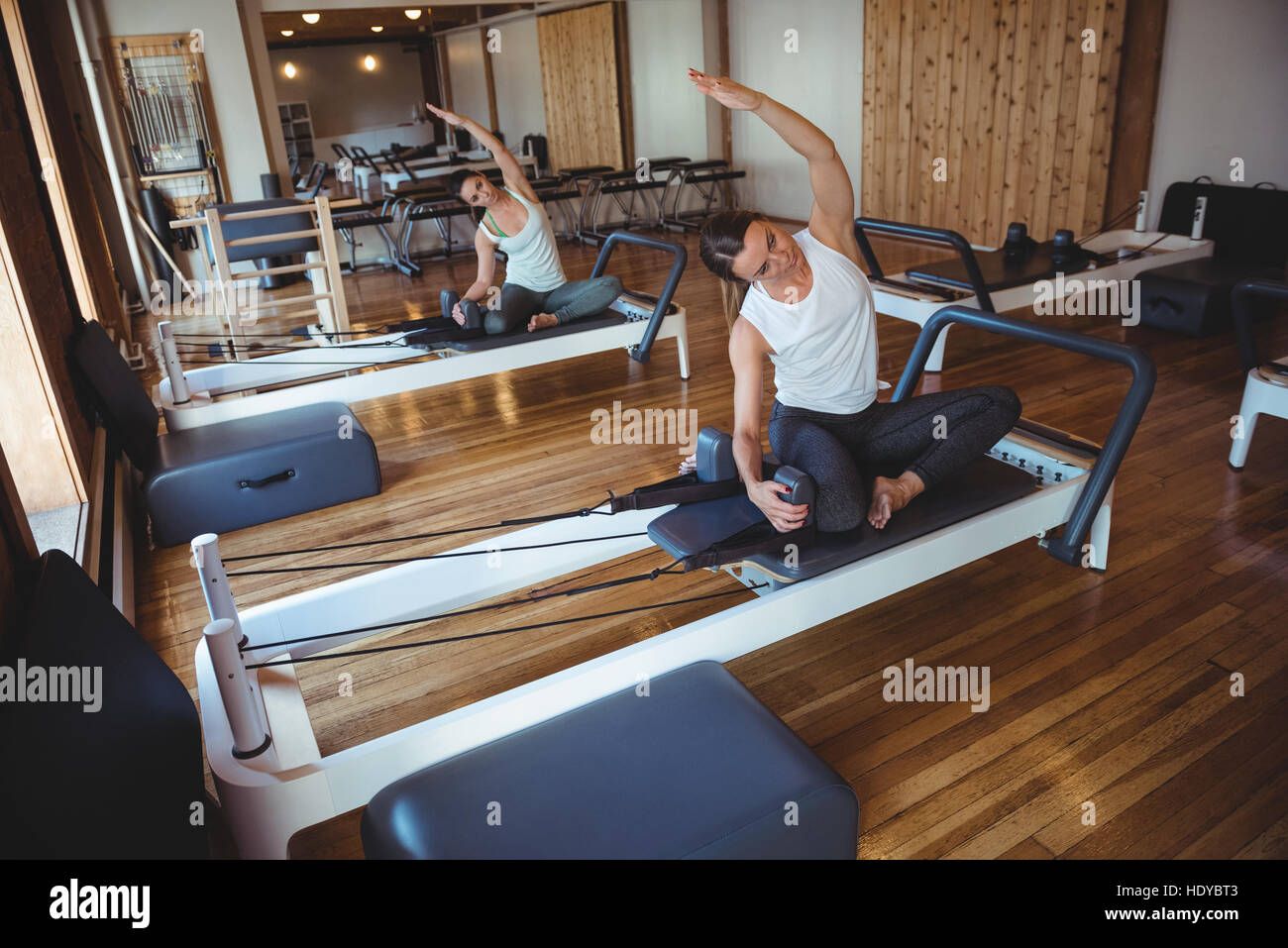 Women practicing pilates on reformer in fitness studio Stock Photo - Alamy