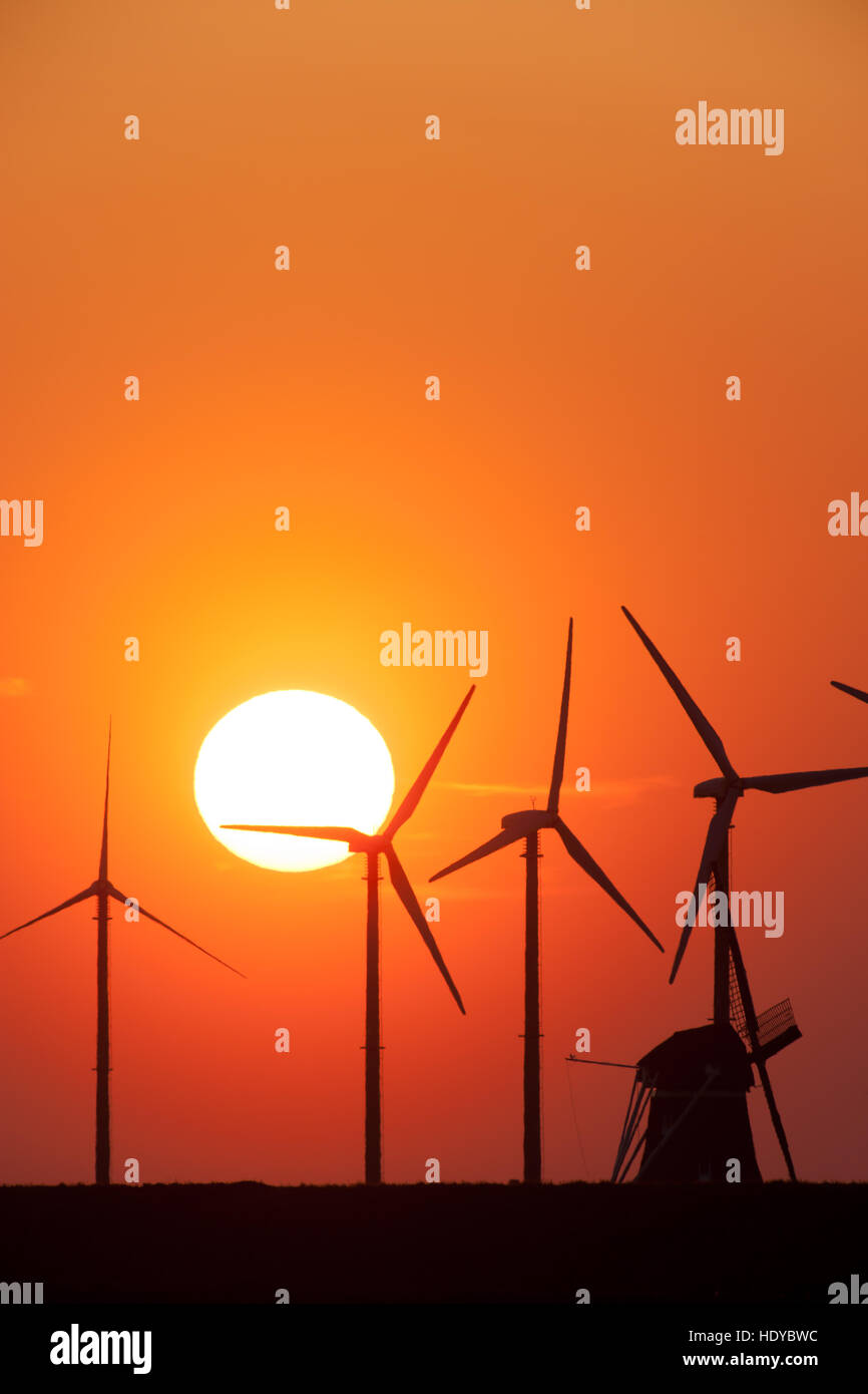 Wind turbines at the Eemshaven at sunset, Groningen, Netherlands Stock ...