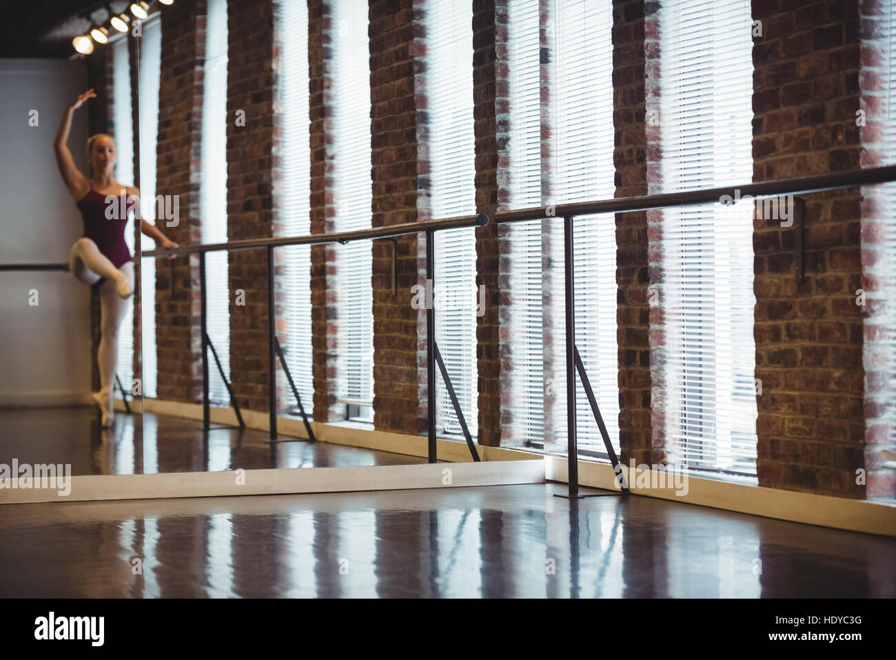 Ballerina practicing ballet dance at barre in ballet studio Stock Photo ...