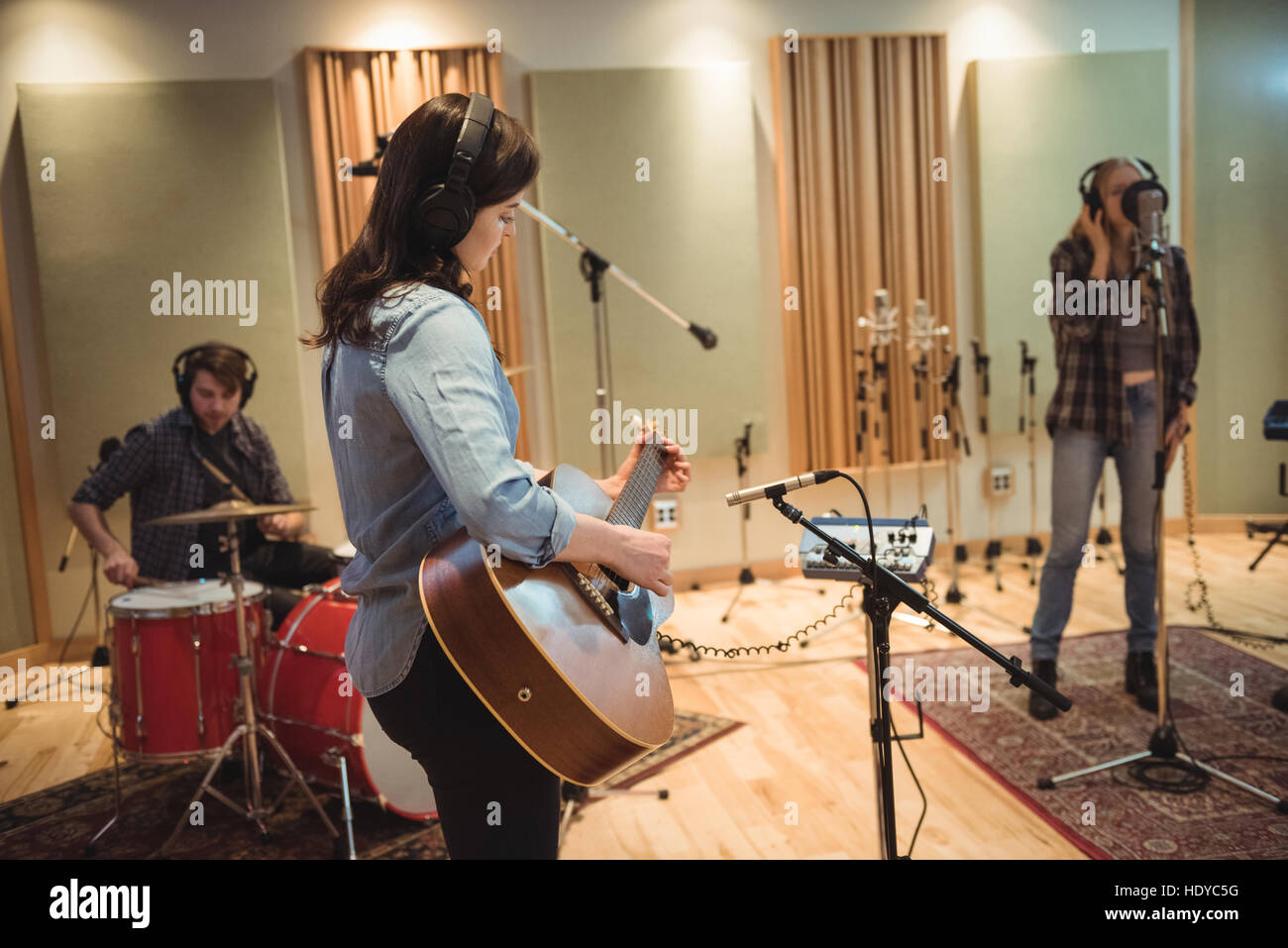Music band performing in a recording studio Stock Photo - Alamy