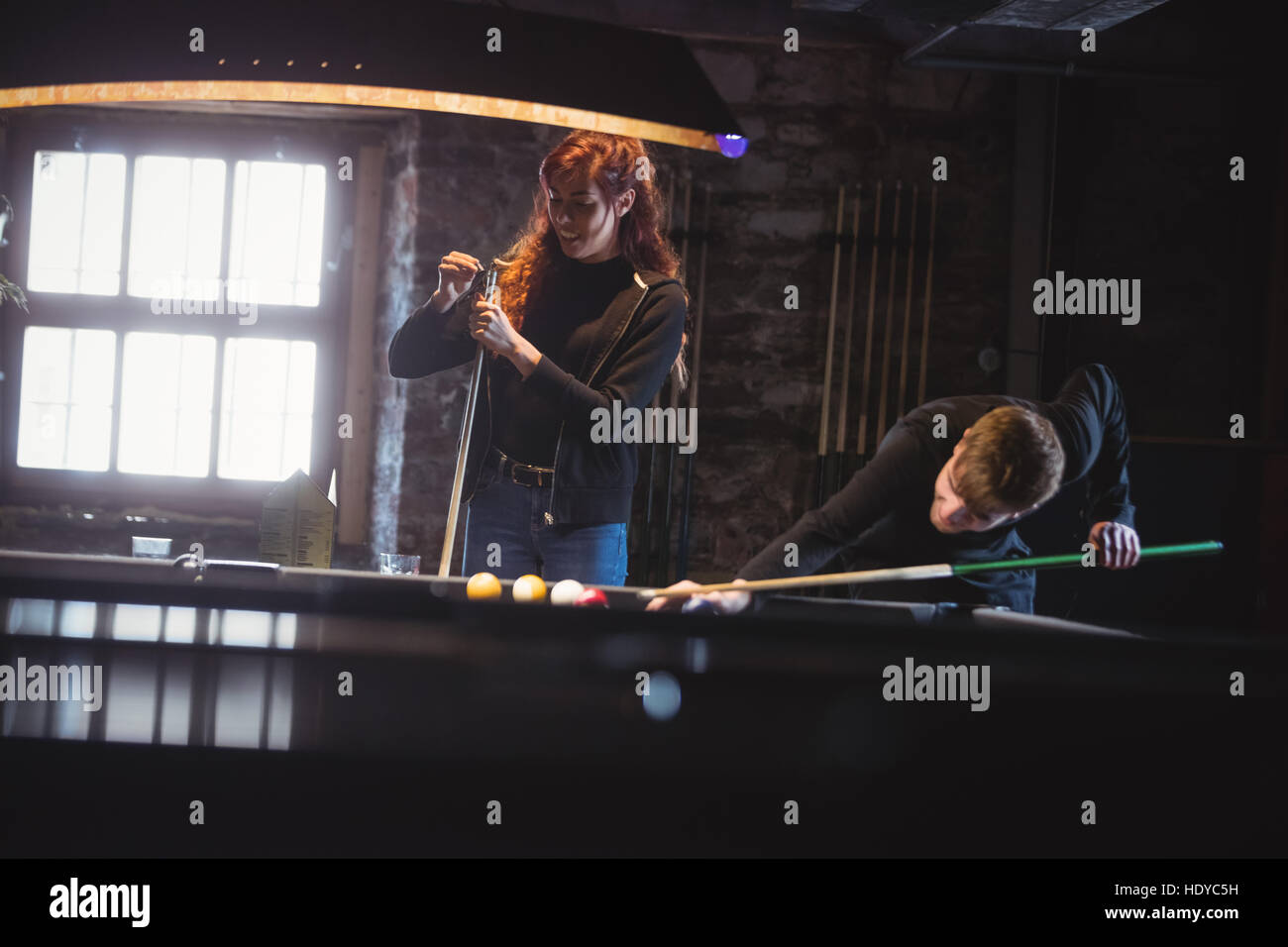 Happy female playing billiard hi-res stock photography and images - Alamy