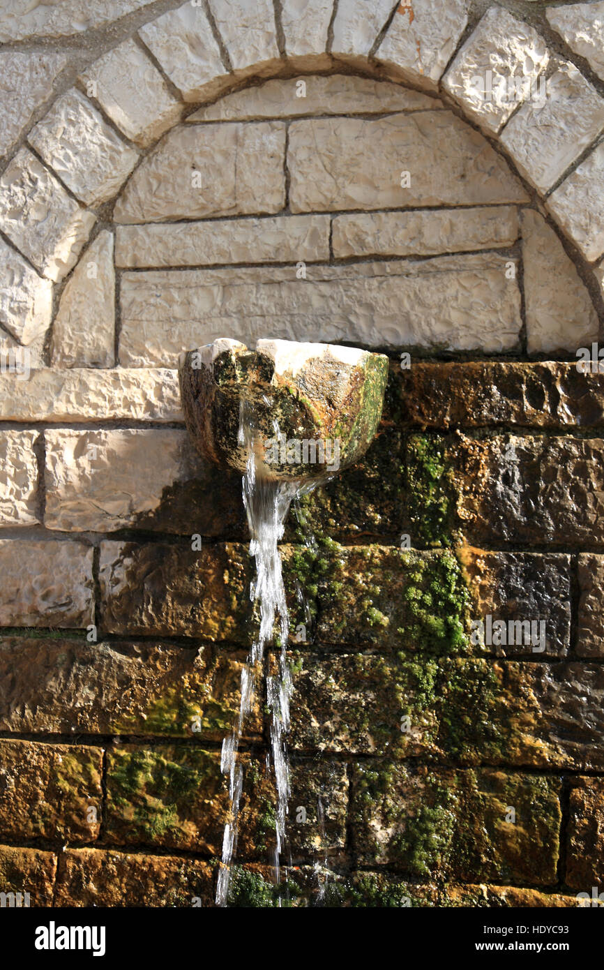 fresh water from a stone builded fountain Stock Photo - Alamy