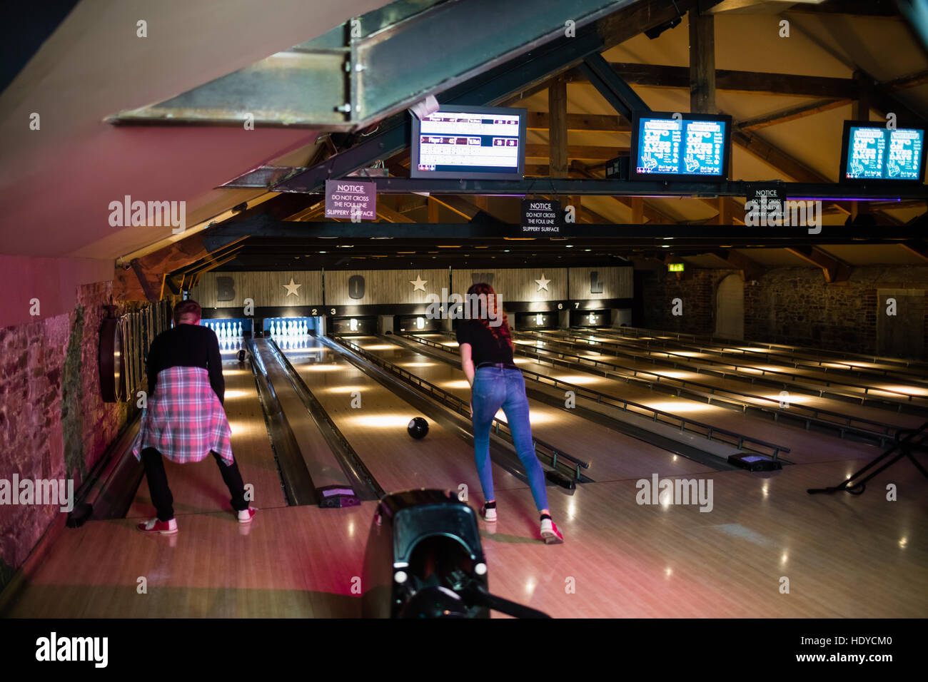 Friends playing bowling in bar Stock Photo - Alamy