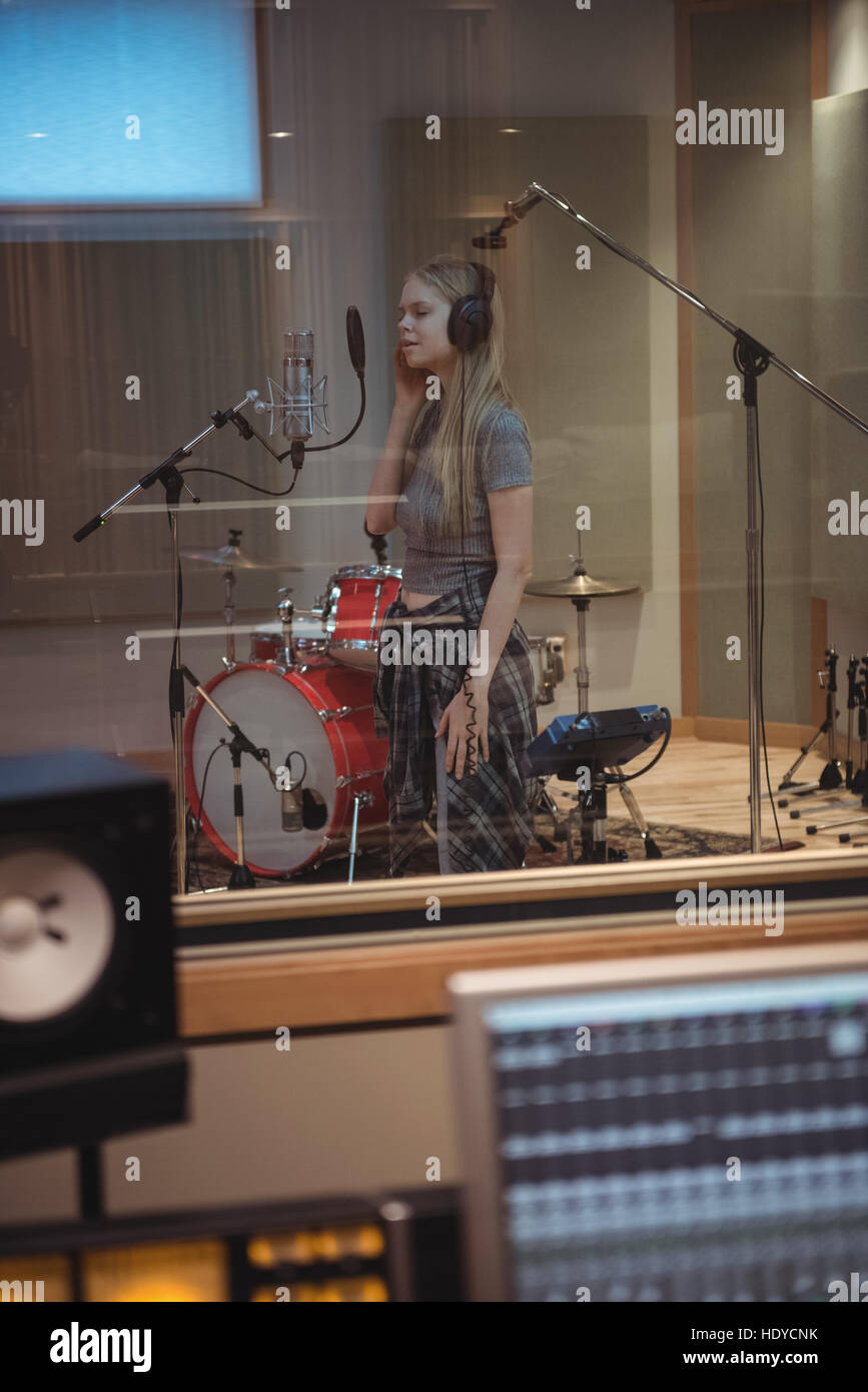 Beautiful woman singing in recording studio Stock Photo - Alamy